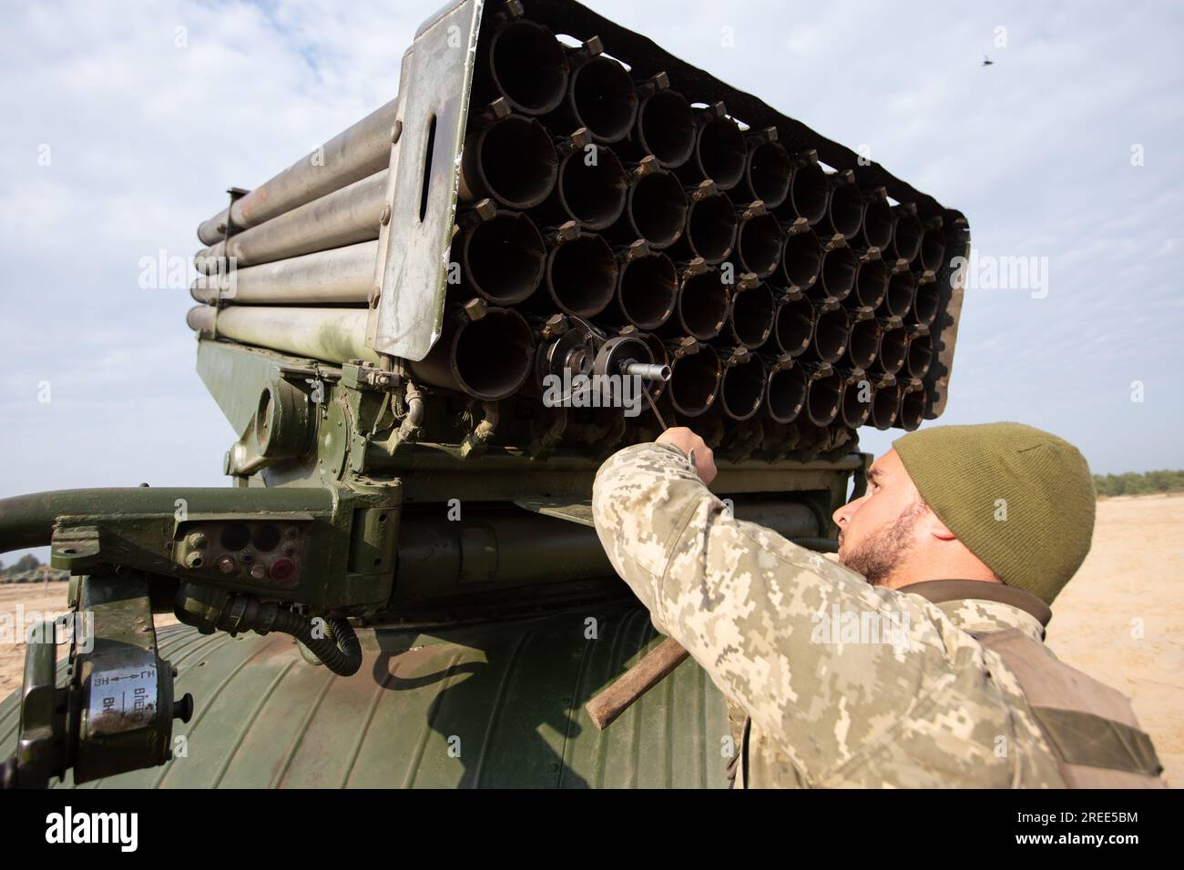 Soldier of Ukrainian army loads a multiple launch rocket system BM-21 ...