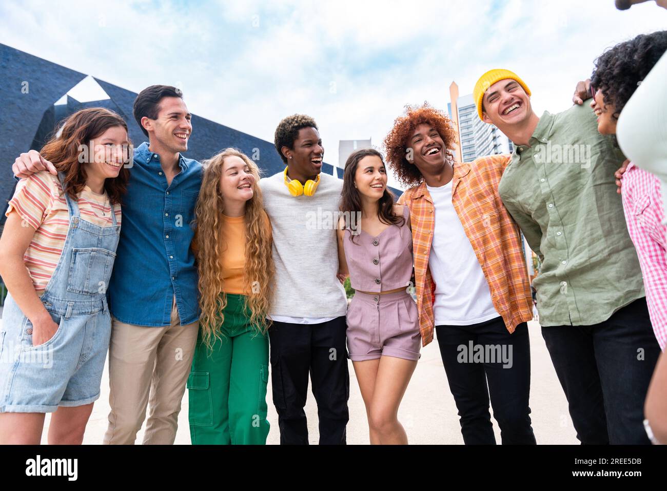 Happy playful multiethnic group of young friends bonding outdoors ...