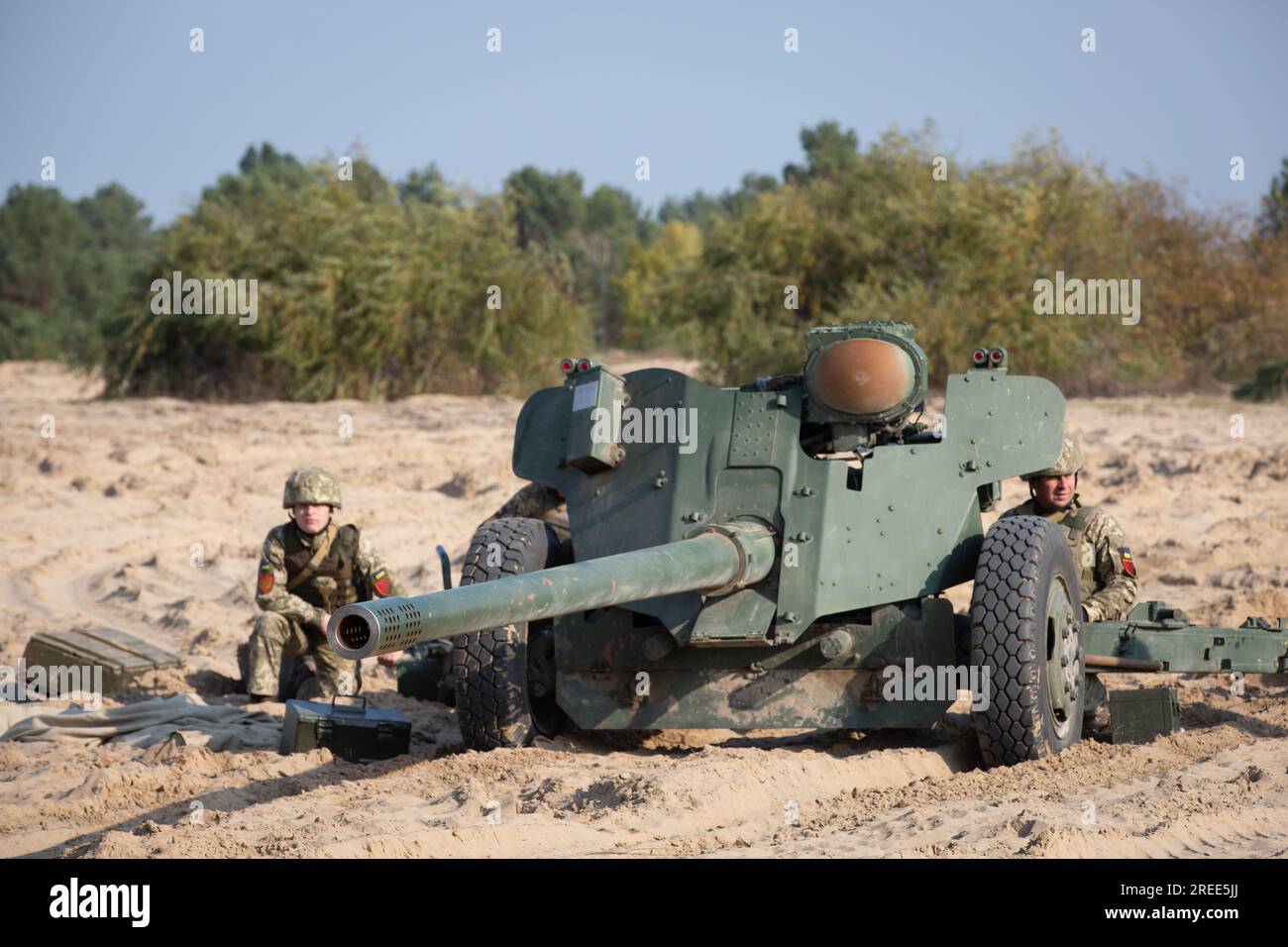 Ukrainian servicemen sits near the anti-tank gun MT-12 Rapier during ...