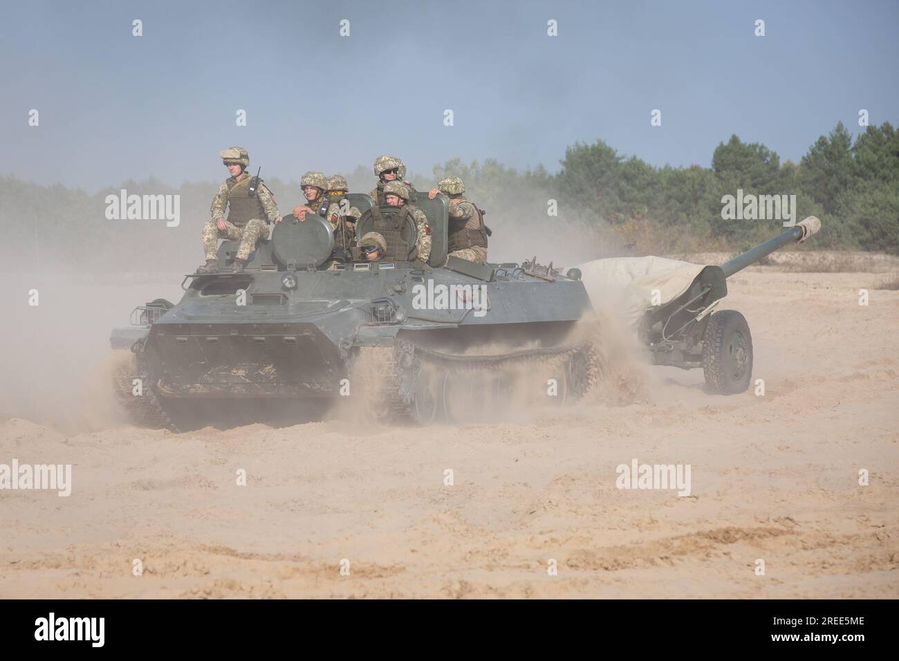 Ukrainian servicemen ride armored personnel carriers at the artillery ...