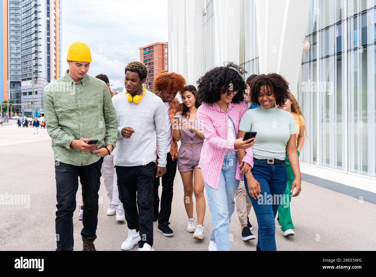 Happy playful multiethnic group of young friends bonding outdoors ...