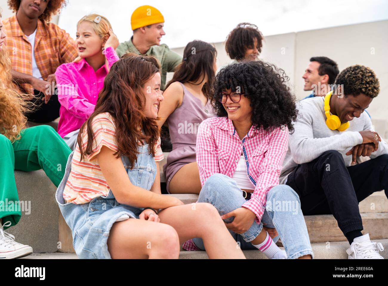 Happy playful multiethnic group of young friends bonding outdoors ...