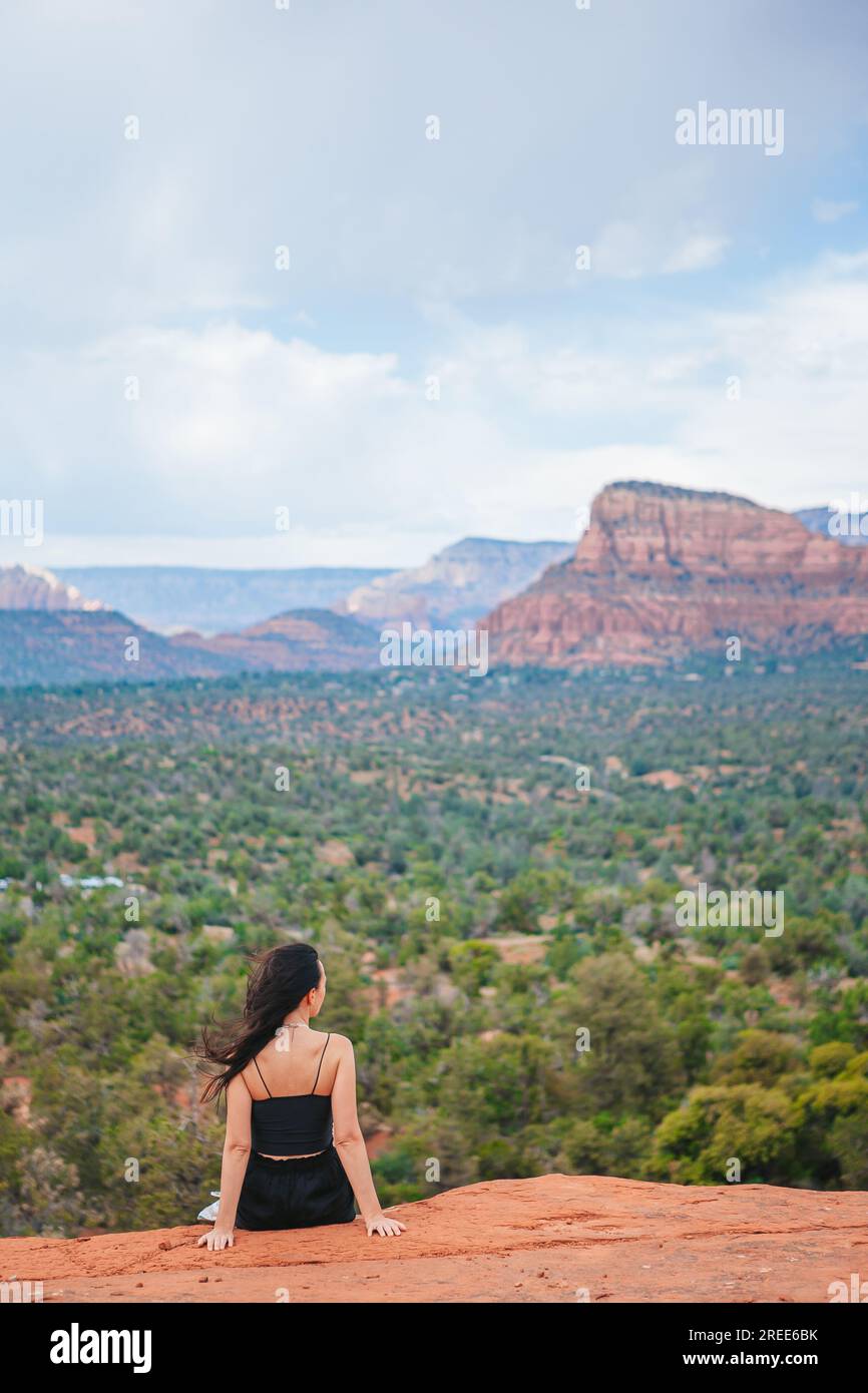 Woman enjoys the view of the Sedona landscape from the top of the Bell ...