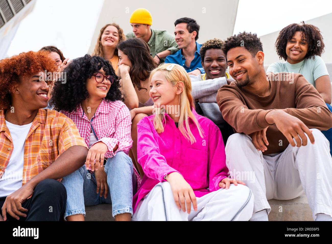 Happy playful multiethnic group of young friends bonding outdoors ...