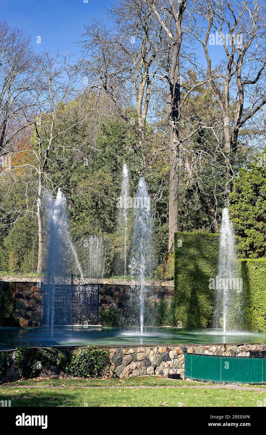 fountains spouting columns, water, trees, stone walls, wrought iron ...