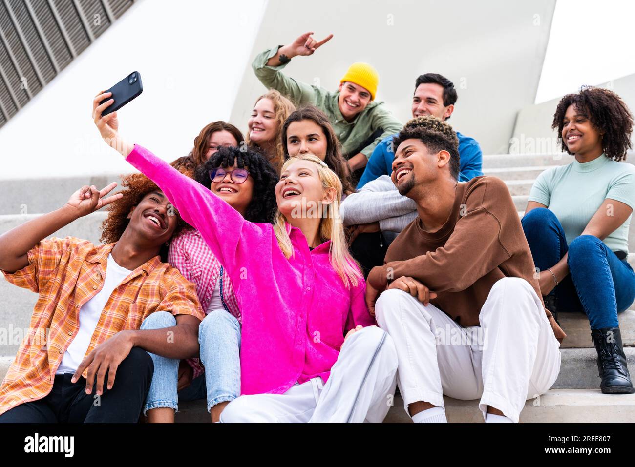 Happy playful multiethnic group of young friends bonding outdoors ...