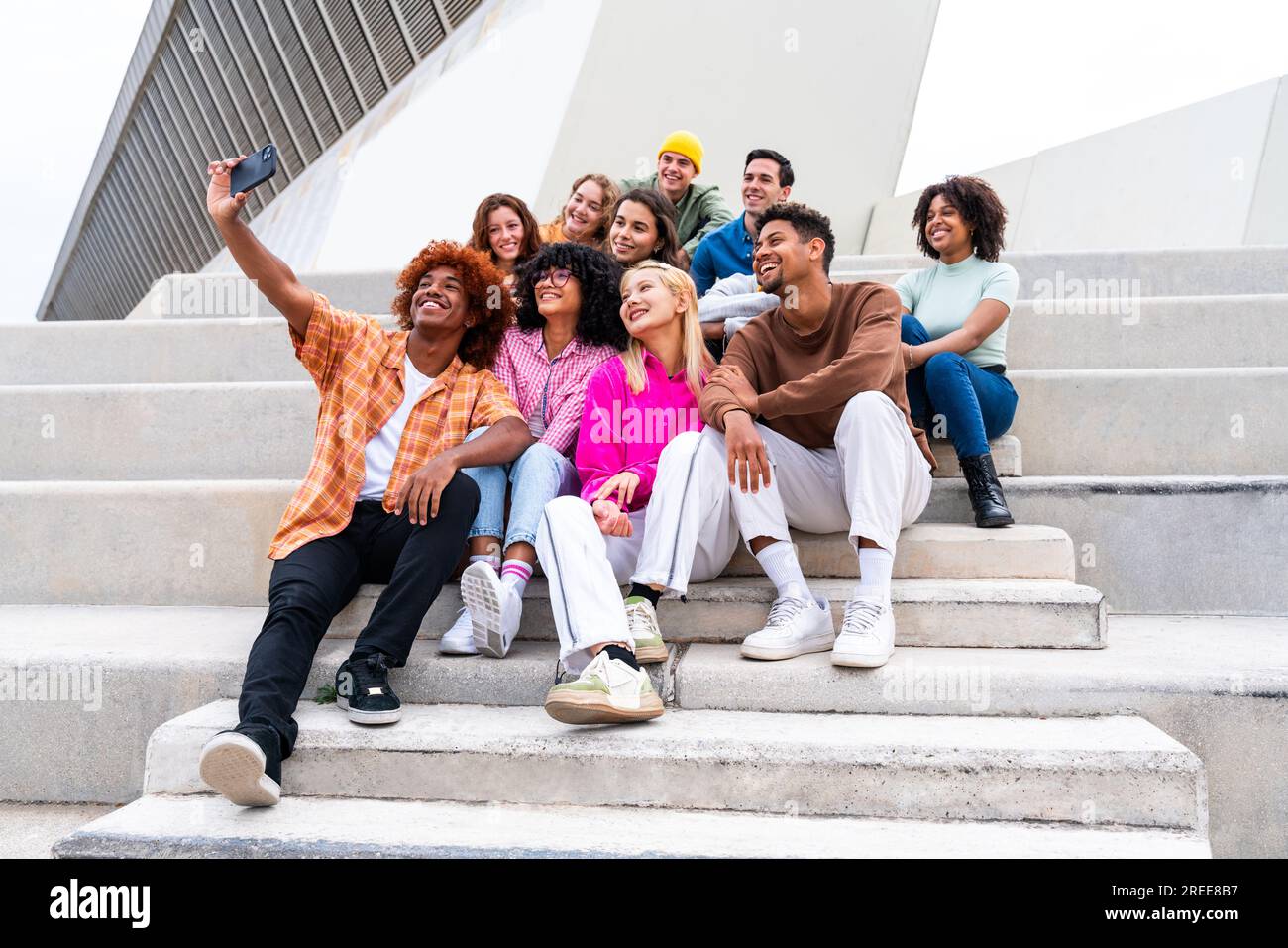 Happy playful multiethnic group of young friends bonding outdoors ...
