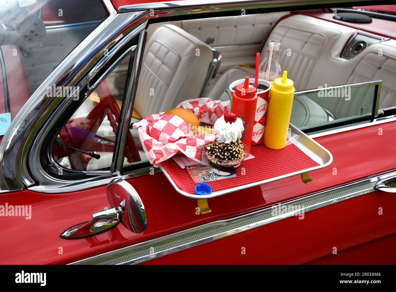A 1950s Chevrolet convertible on display at a car show features a drive ...