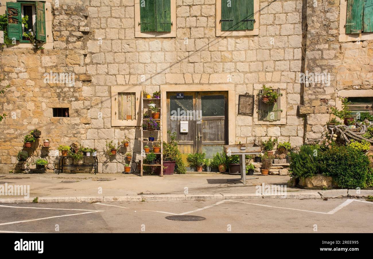 Kastela, Croatia - May 19th 2023. An old stone house in the historic ...