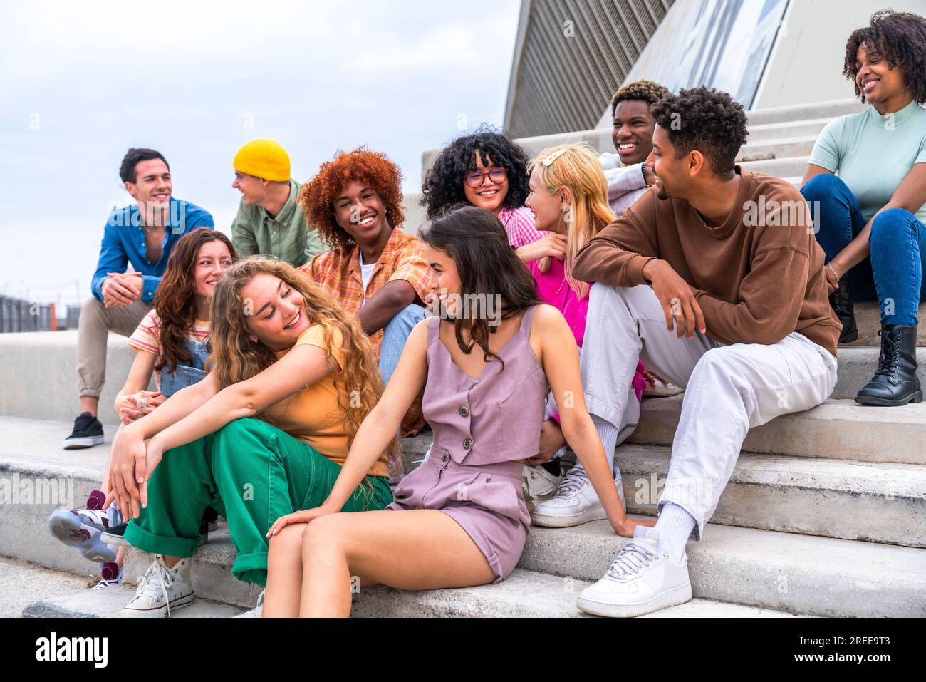 Happy playful multiethnic group of young friends bonding outdoors ...