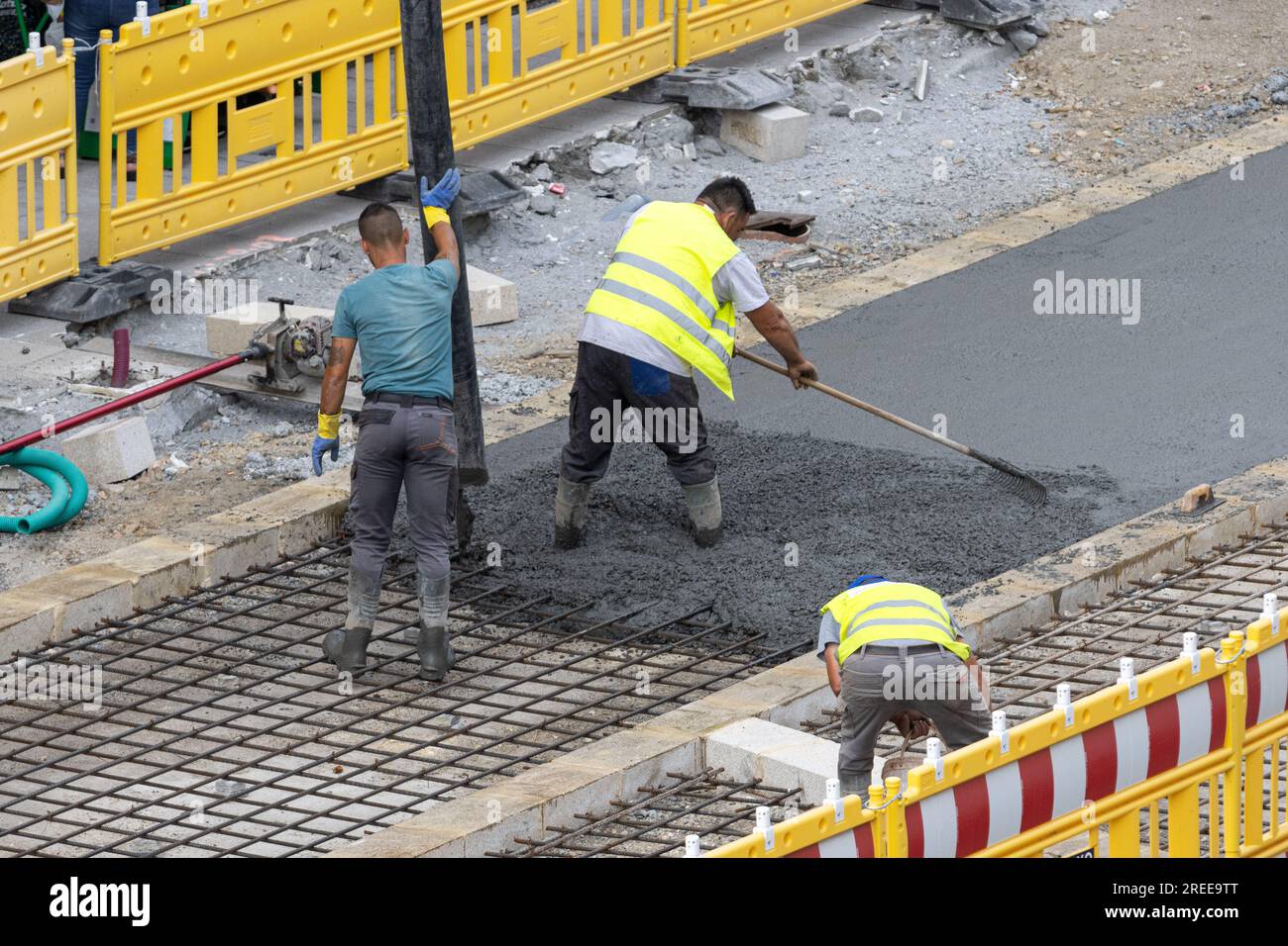 Galicia, Spain; july 20, 2023: Workers working on a city road pouring ...