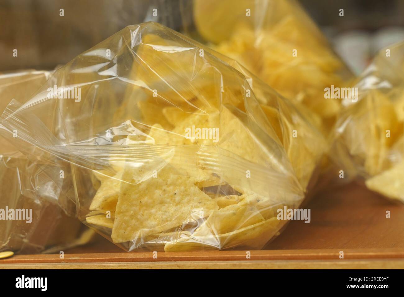 On the shop window are triangular-shaped potato chips in a transparent ...