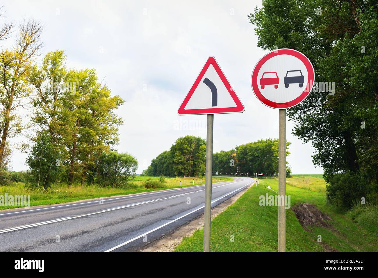 Road signs, overtaking is prohibited and a dangerous turn on the ...