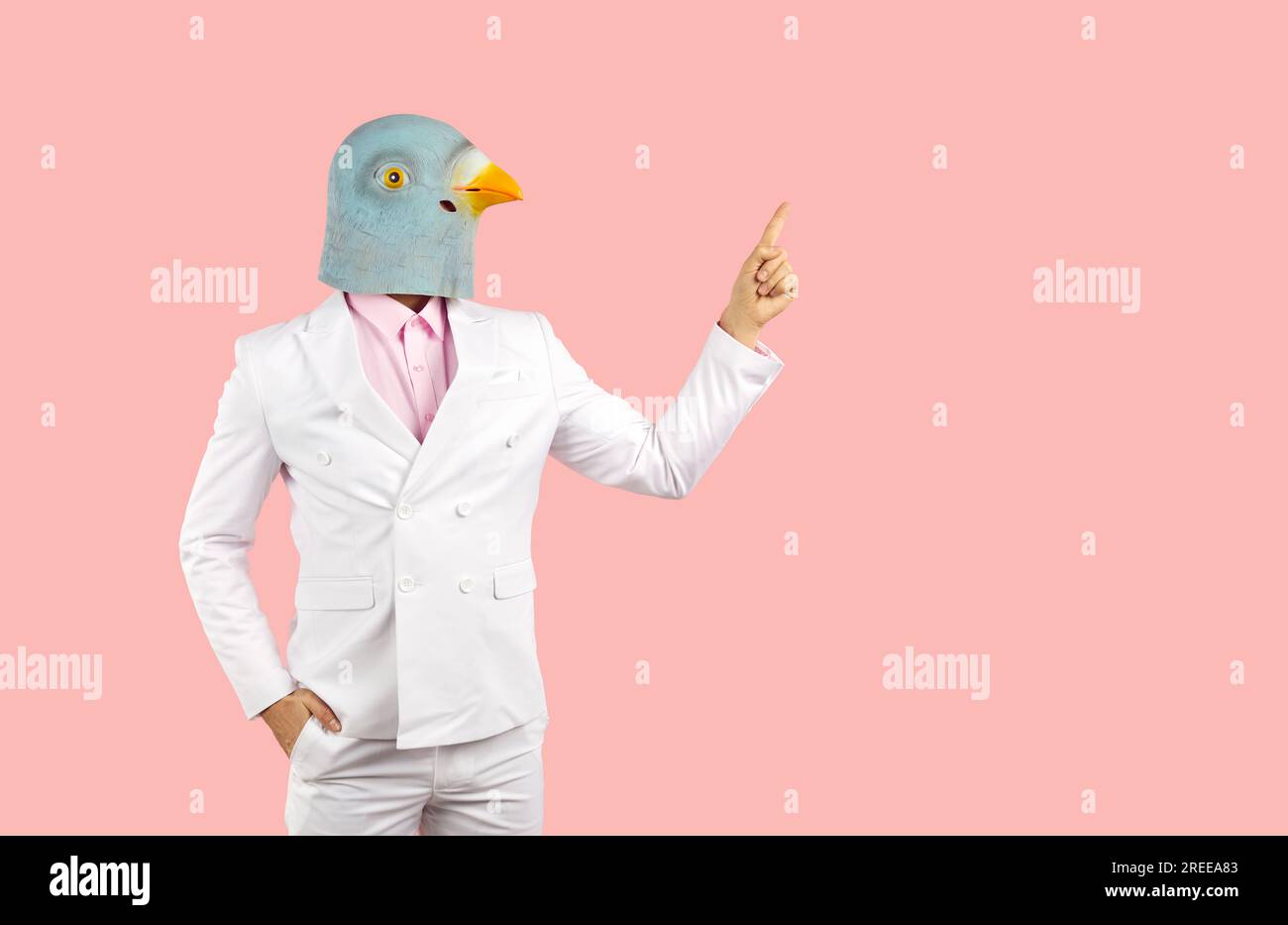 Strange man in funny pigeon mask showing something and pointing his ...