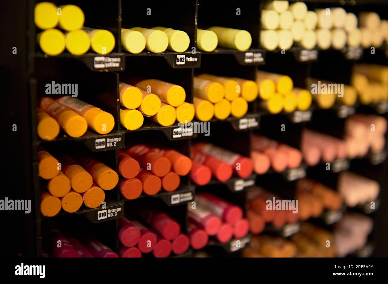 Selective focus on bright colorful pencils in warm colors spectrum for ...