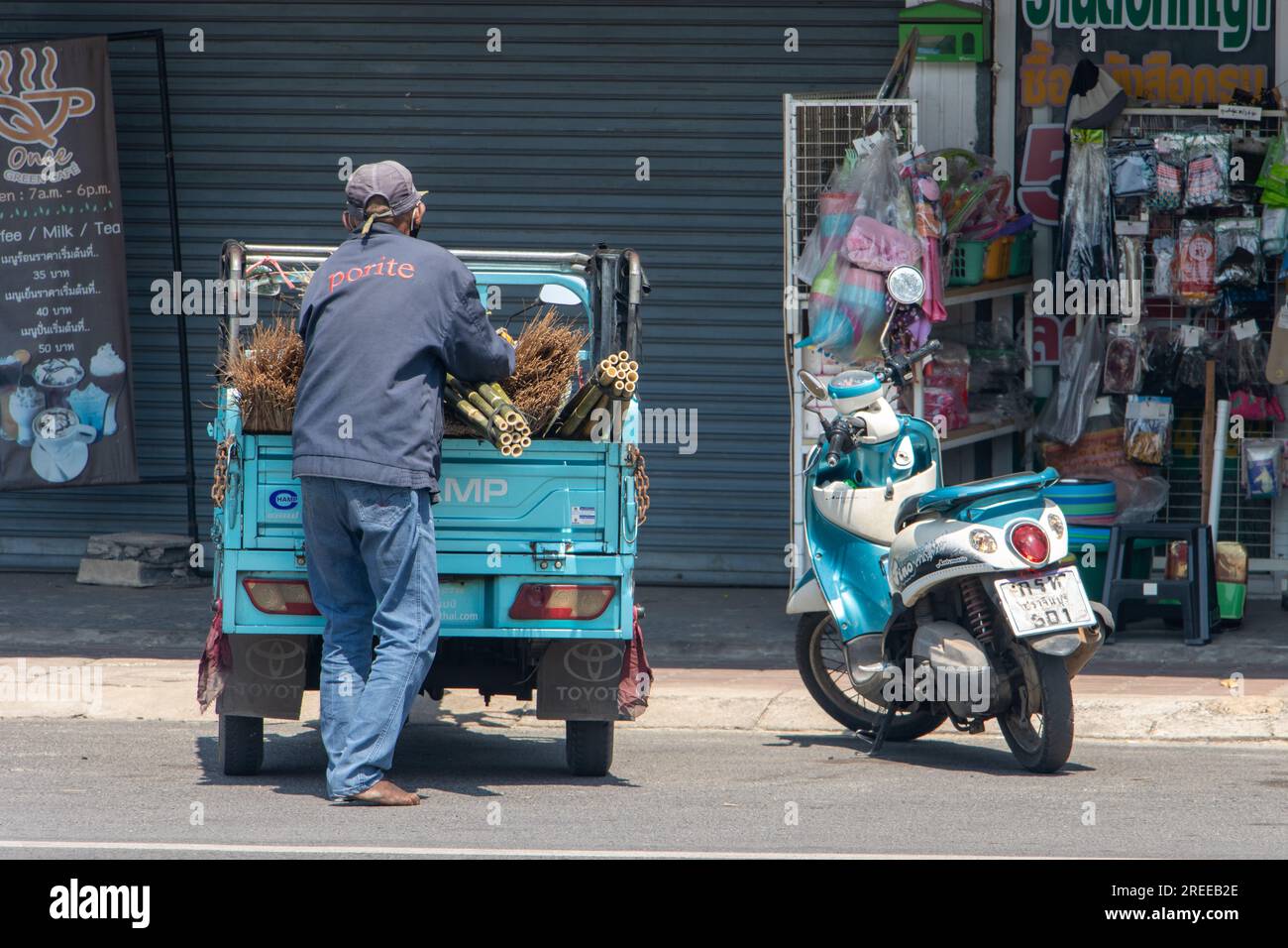 PRACHIN BURI, THAILAND, FEB 26 2023, A man unloads a load of handmade ...