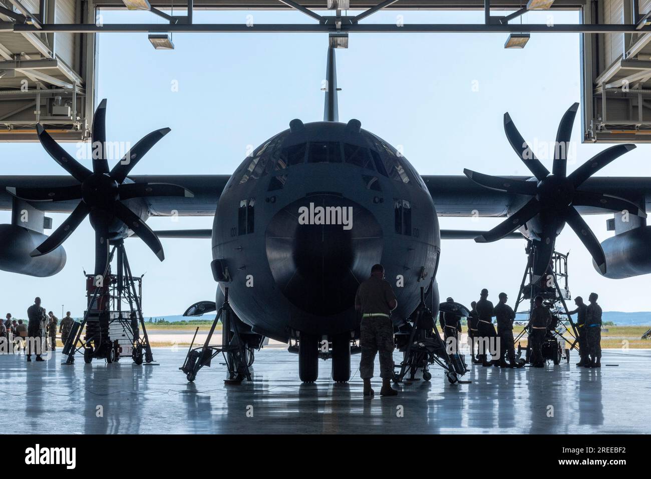 A U.S. Air Force C-130 Hercules is parked in a hangar for maintenance ...