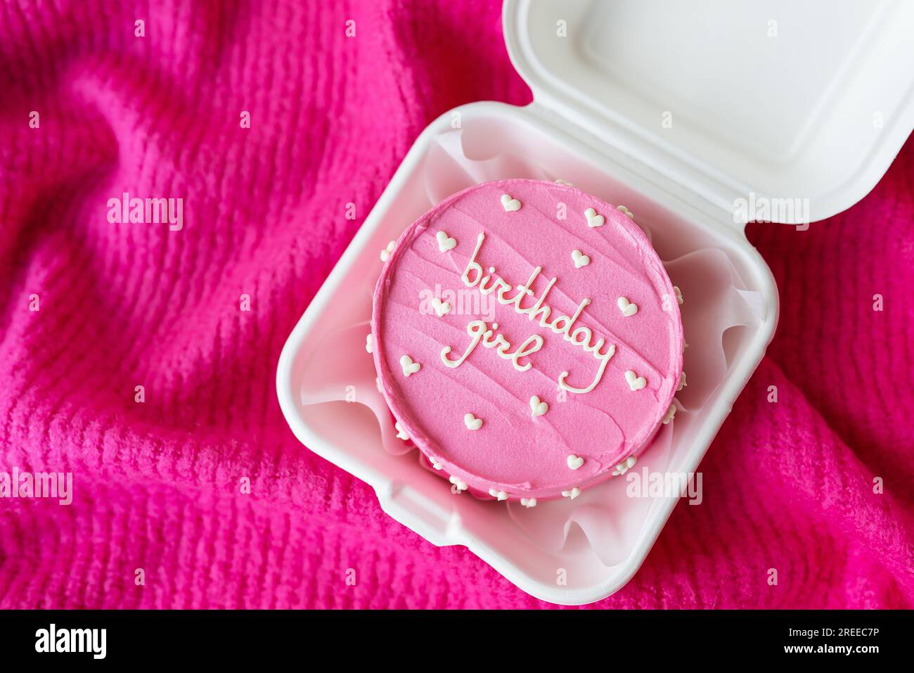 Beautiful bright pink bento cake with an inscription on a pink ...
