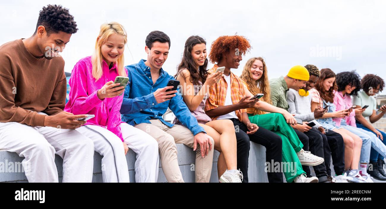 Happy playful multiethnic group of young friends bonding outdoors ...