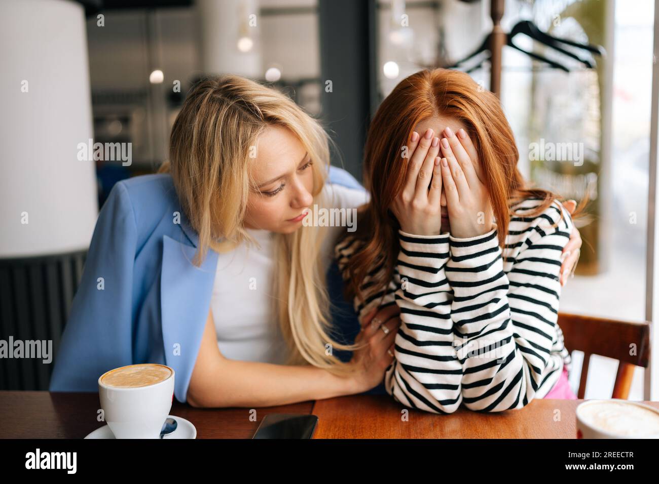 Woman crying with friend cafe hi-res stock photography and images - Alamy