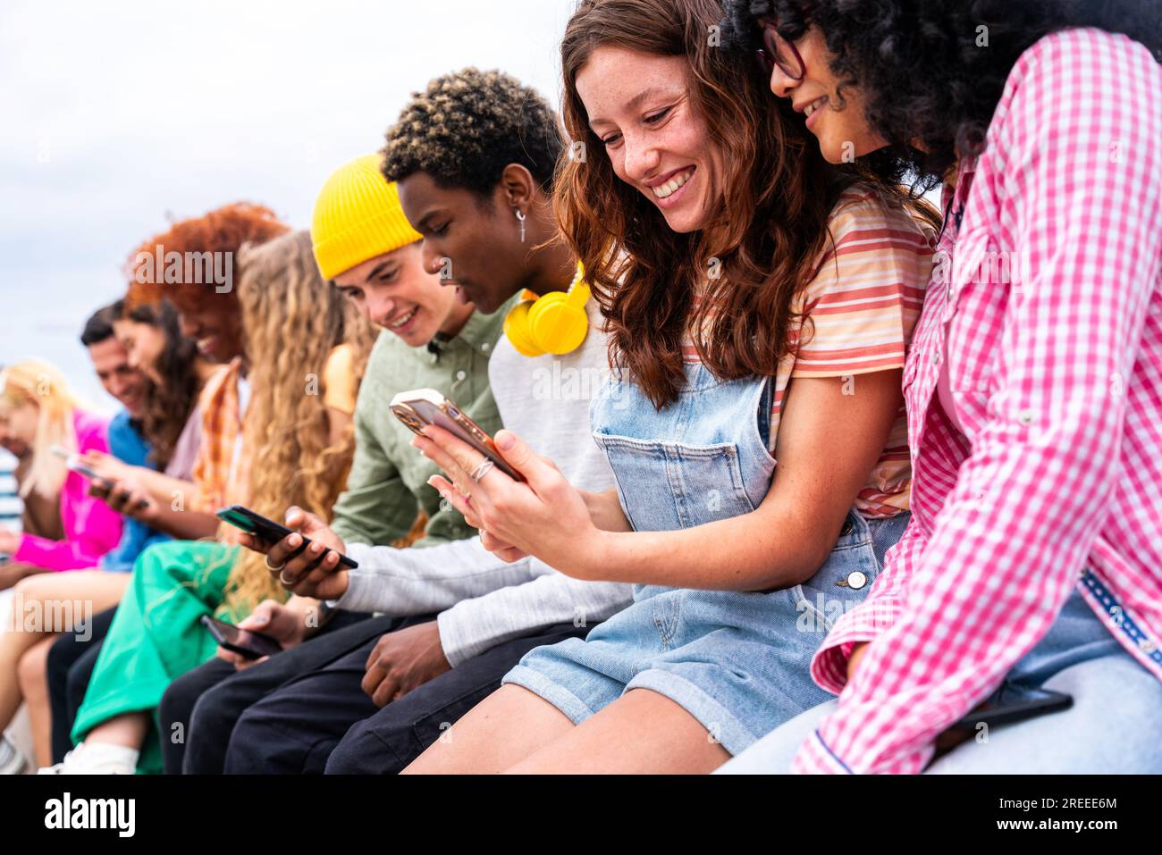 Happy playful multiethnic group of young friends bonding outdoors ...
