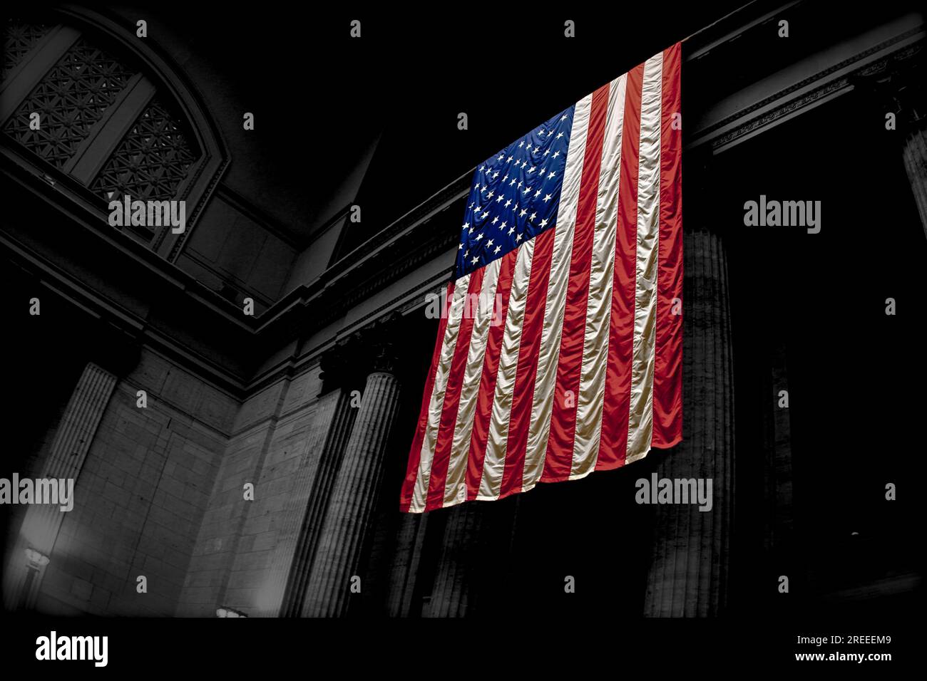 American flag hangs in large building Stock Photo - Alamy