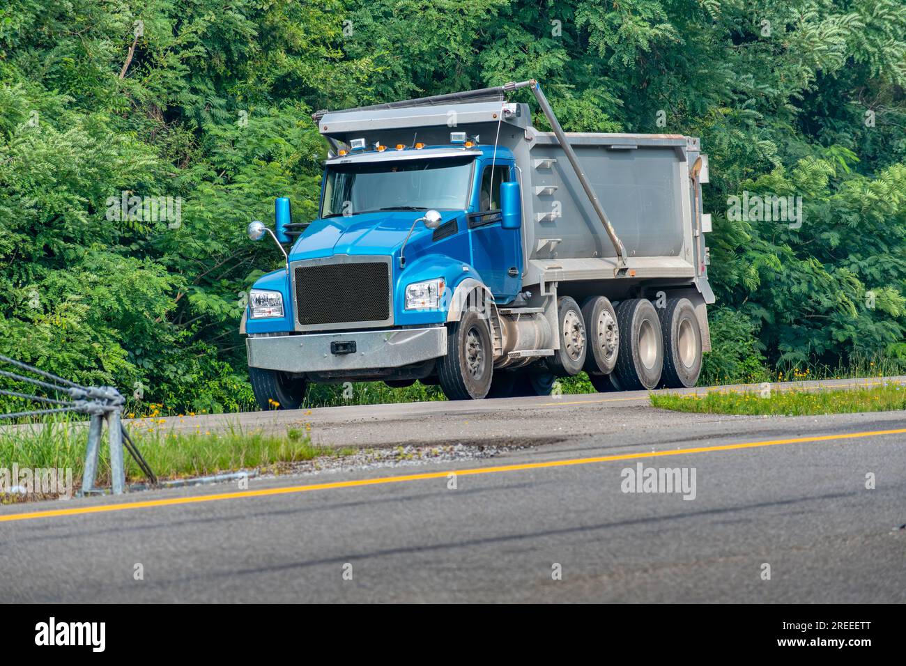 Horizontal shot of a blue dump truck on a divided highway Stock Photo ...