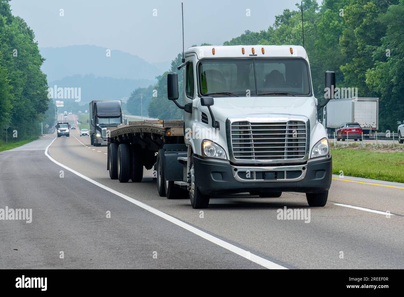 Horizontal shot of a white eighteen wheeler on a foggy Tennessee ...