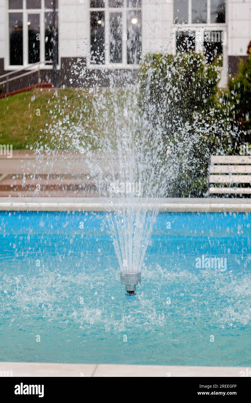 photo of water falling down from a small fountain, splashing water ...
