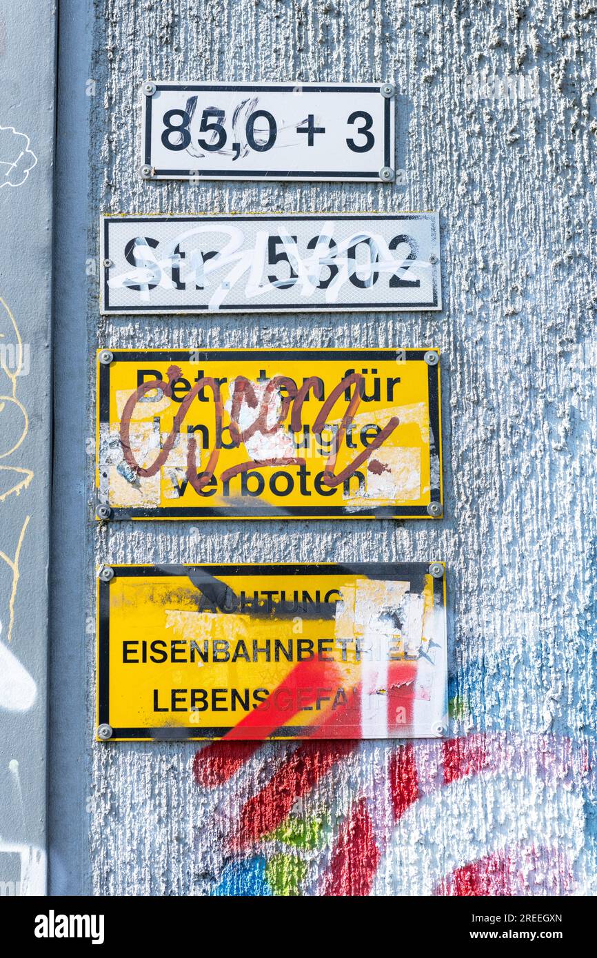 Signs defaced by sprayer on a wall, trespassing prohibited, Ulm, Baden ...
