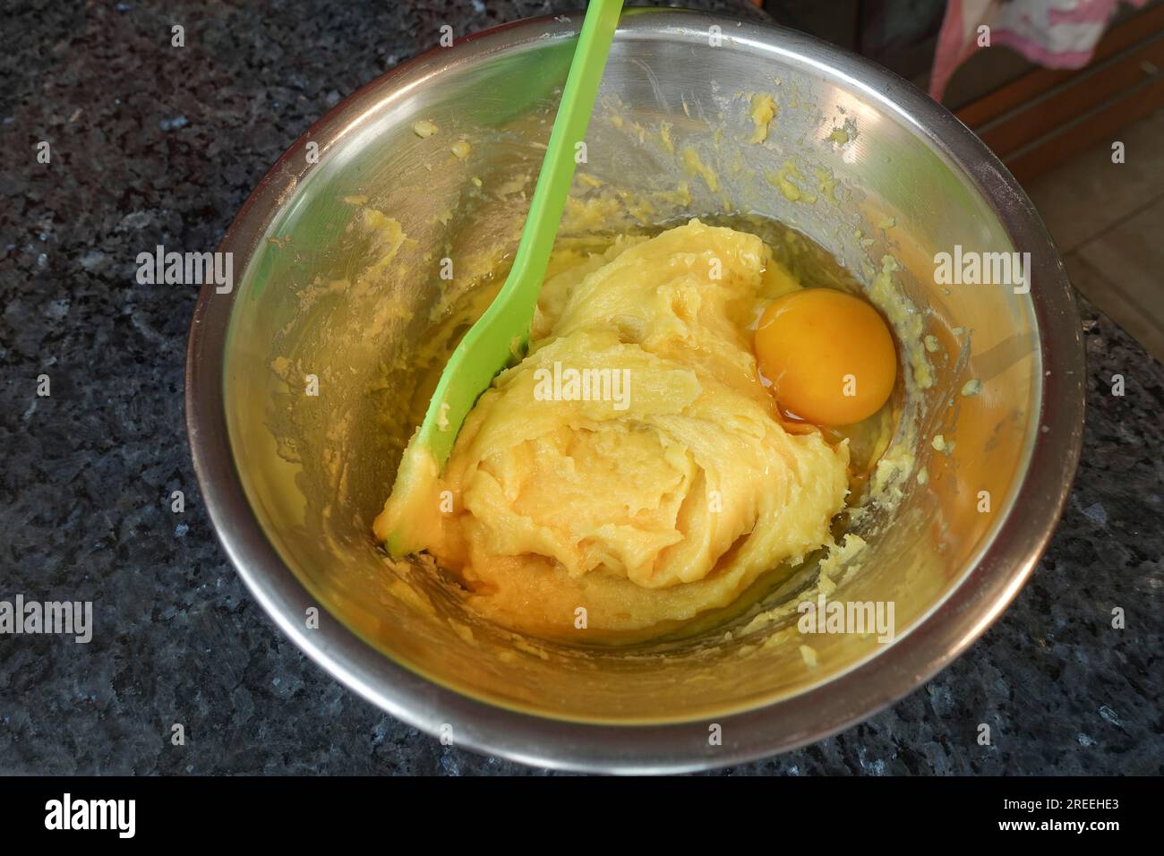 Swabian cuisine, preparing choux pastry for mini cream puffs, adding ...