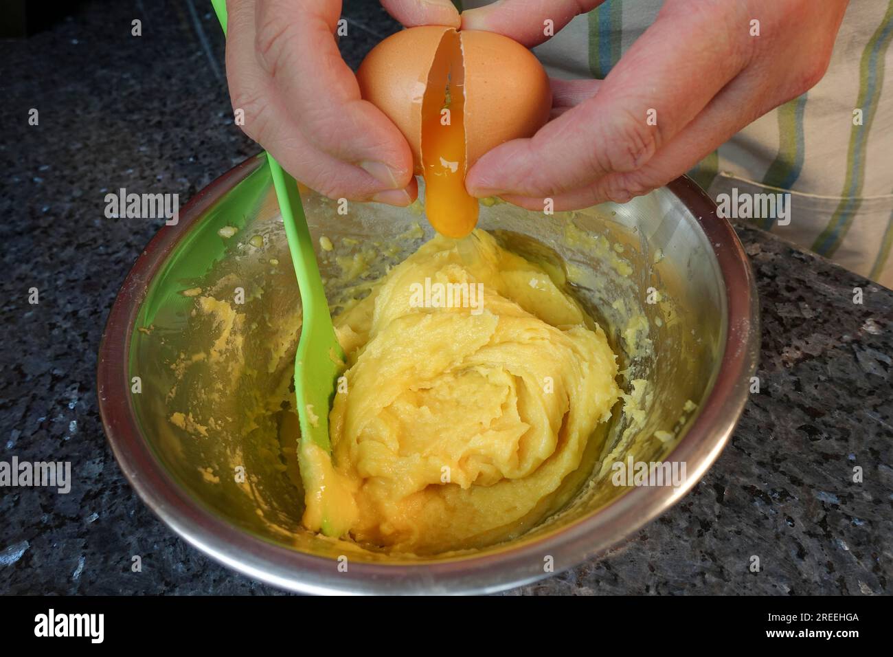 Swabian cuisine, preparing choux pastry for mini cream puffs, adding ...