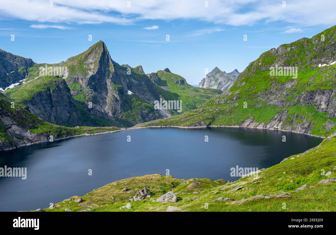 Lake Tennesvatnet and mountain landscape with rocky pointed peaks ...
