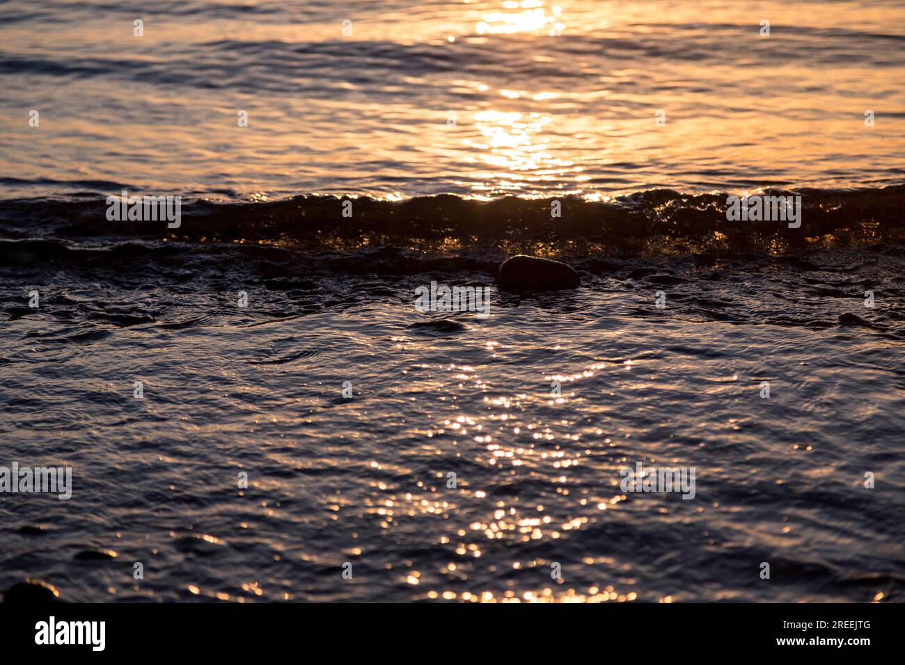 Ocean ripples at the sunset for backgrounds Stock Photo - Alamy