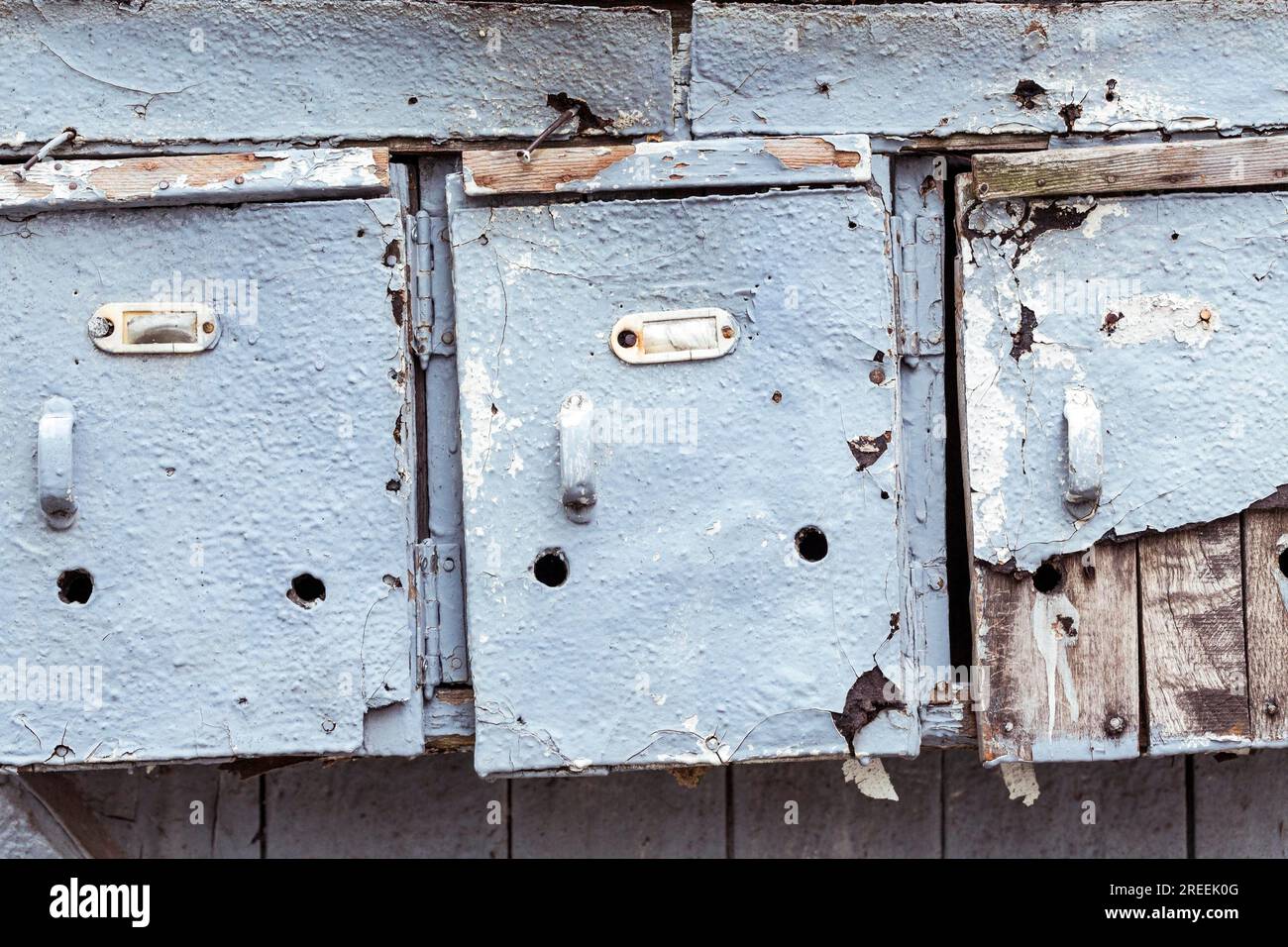 Three very old and grungy mailboxes Stock Photo - Alamy