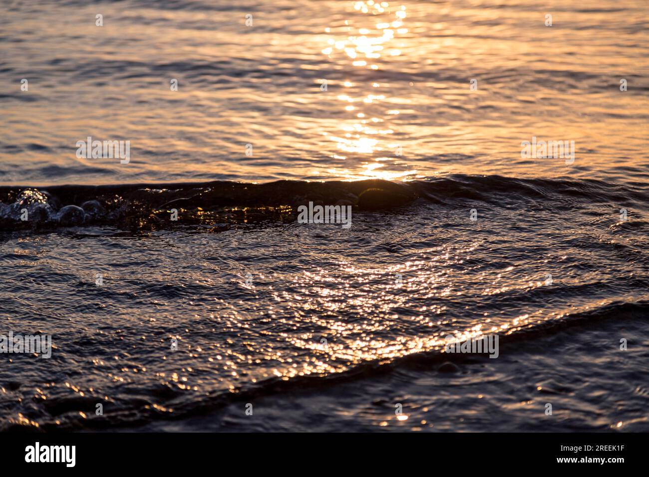 Ocean ripples at the sunset for backgrounds Stock Photo - Alamy