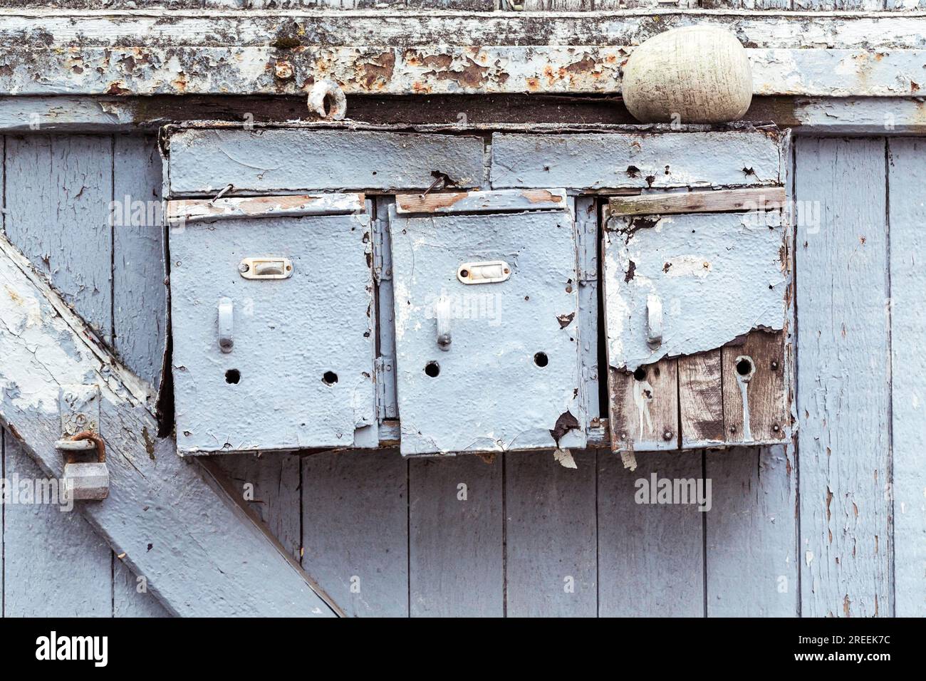 Three very old and grungy mailboxes at a gate Stock Photo - Alamy
