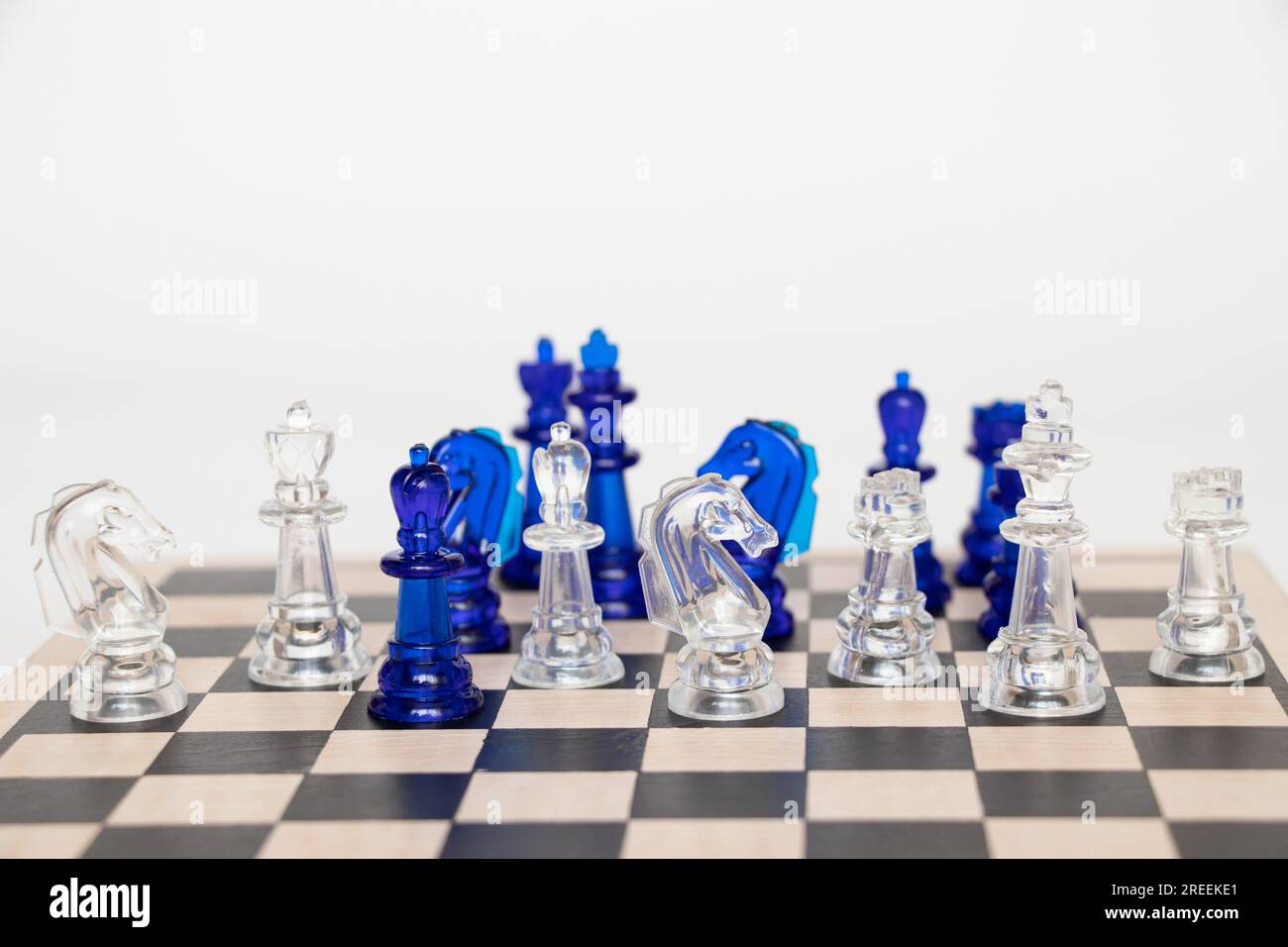 Transparent chess on a chessboard close-up, chess game and hobby Stock ...