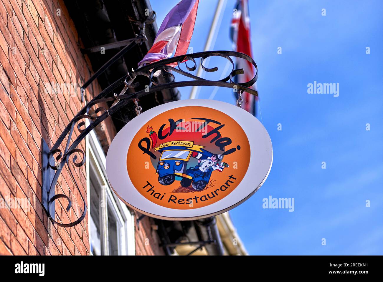 Thai restaurant sign against a blue summer sky Stock Photo - Alamy