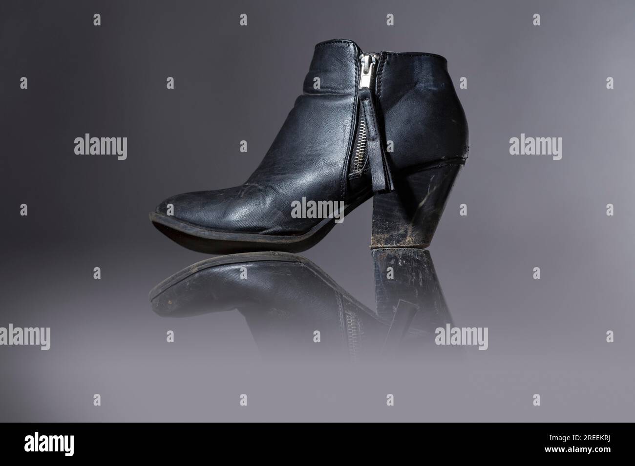 Old, damaged female shoes with gray background Stock Photo - Alamy