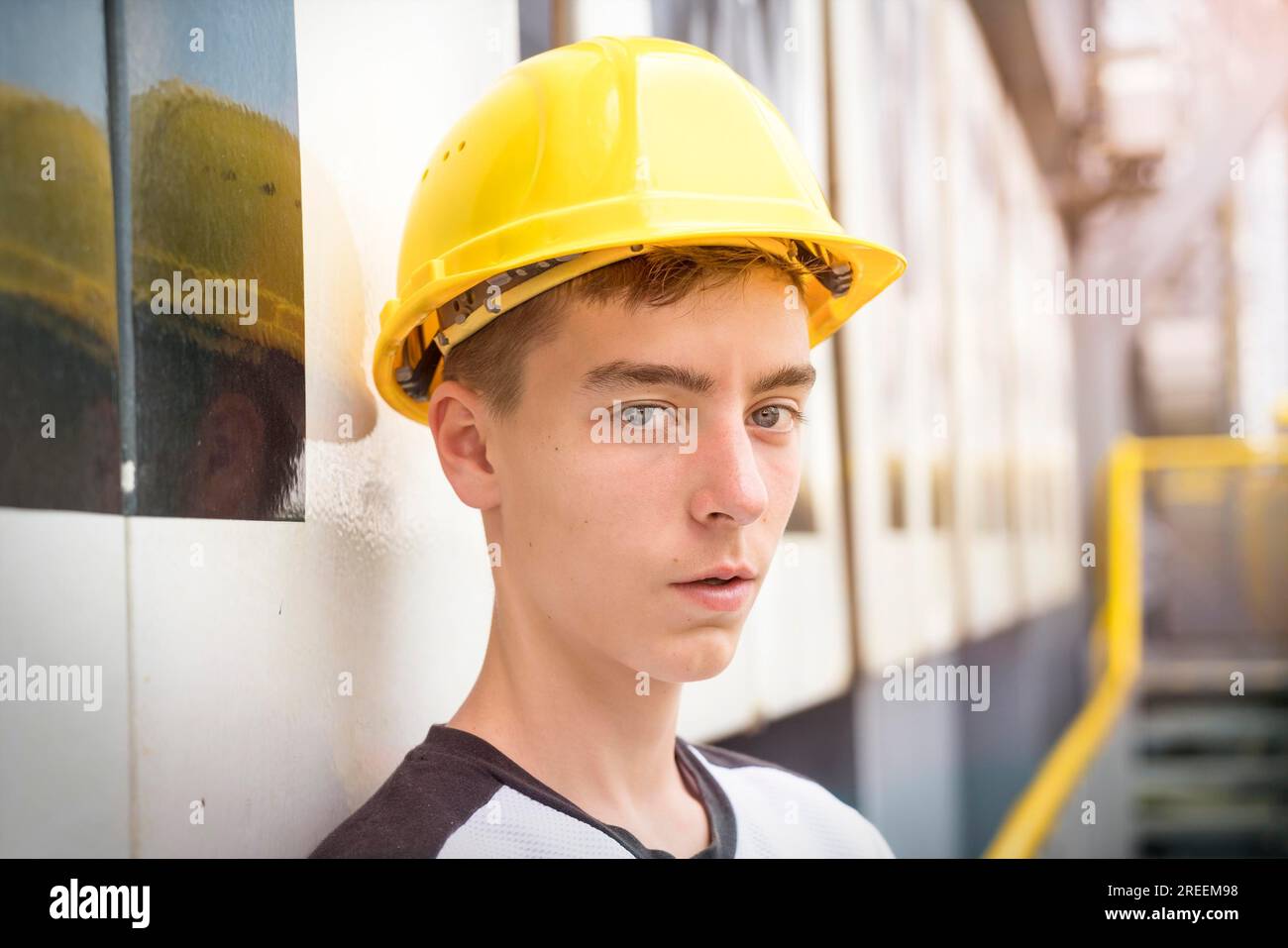 Portrait of a young man with yellow safety helmet Stock Photo - Alamy