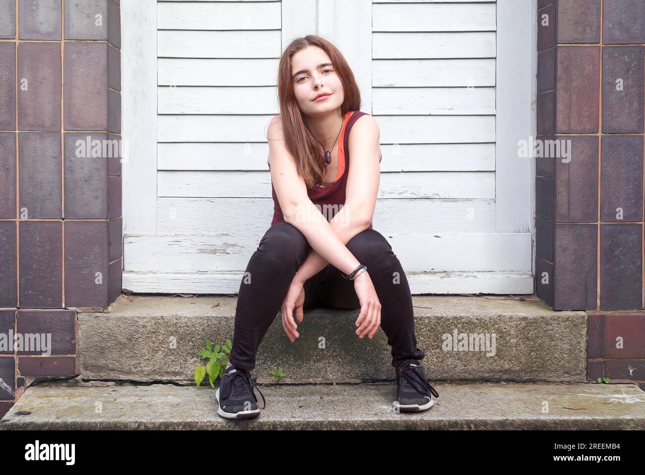Portrait woman sitting on step hi-res stock photography and images - Alamy