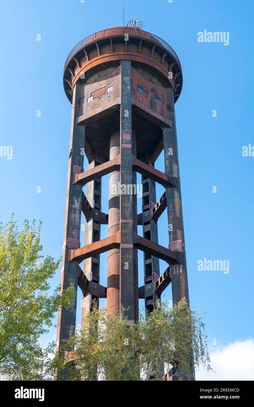 Old rusty water tower and clear blue sky Stock Photo - Alamy