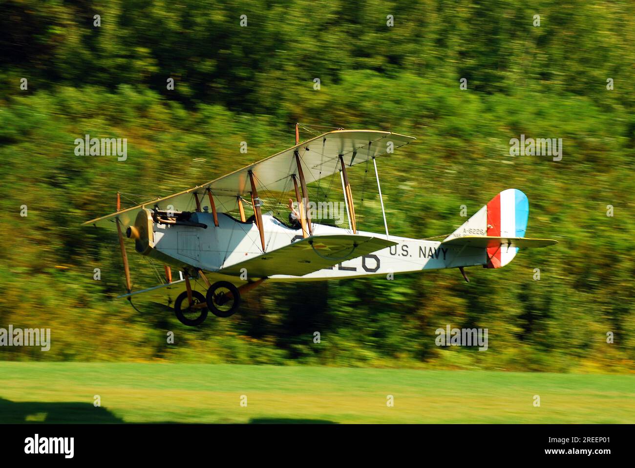 The pilot waves as his historic Curtiss JN 4H airplane takes off from a ...