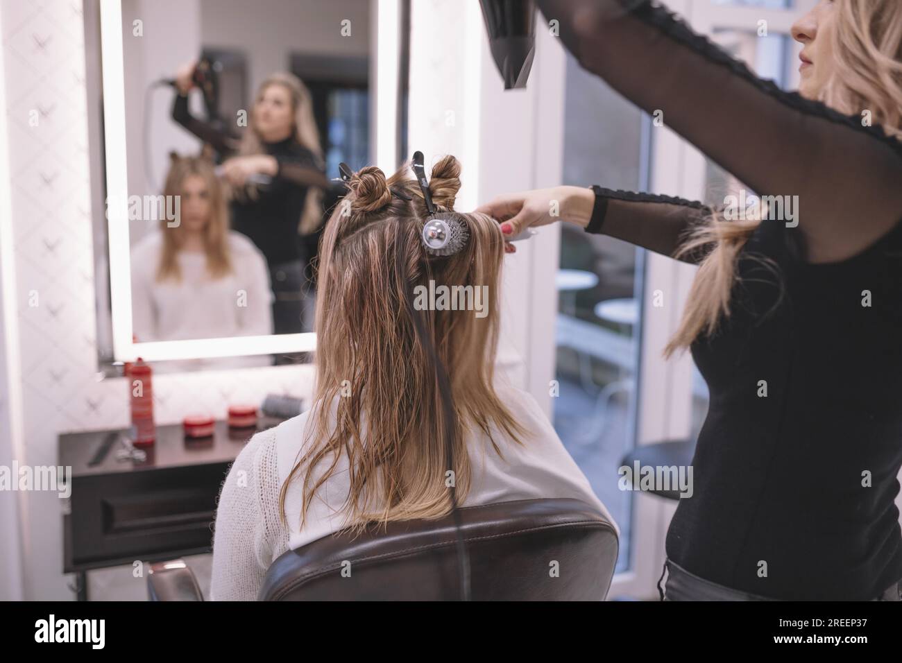 Professional hairstylist setting hair client. Resolution and high ...