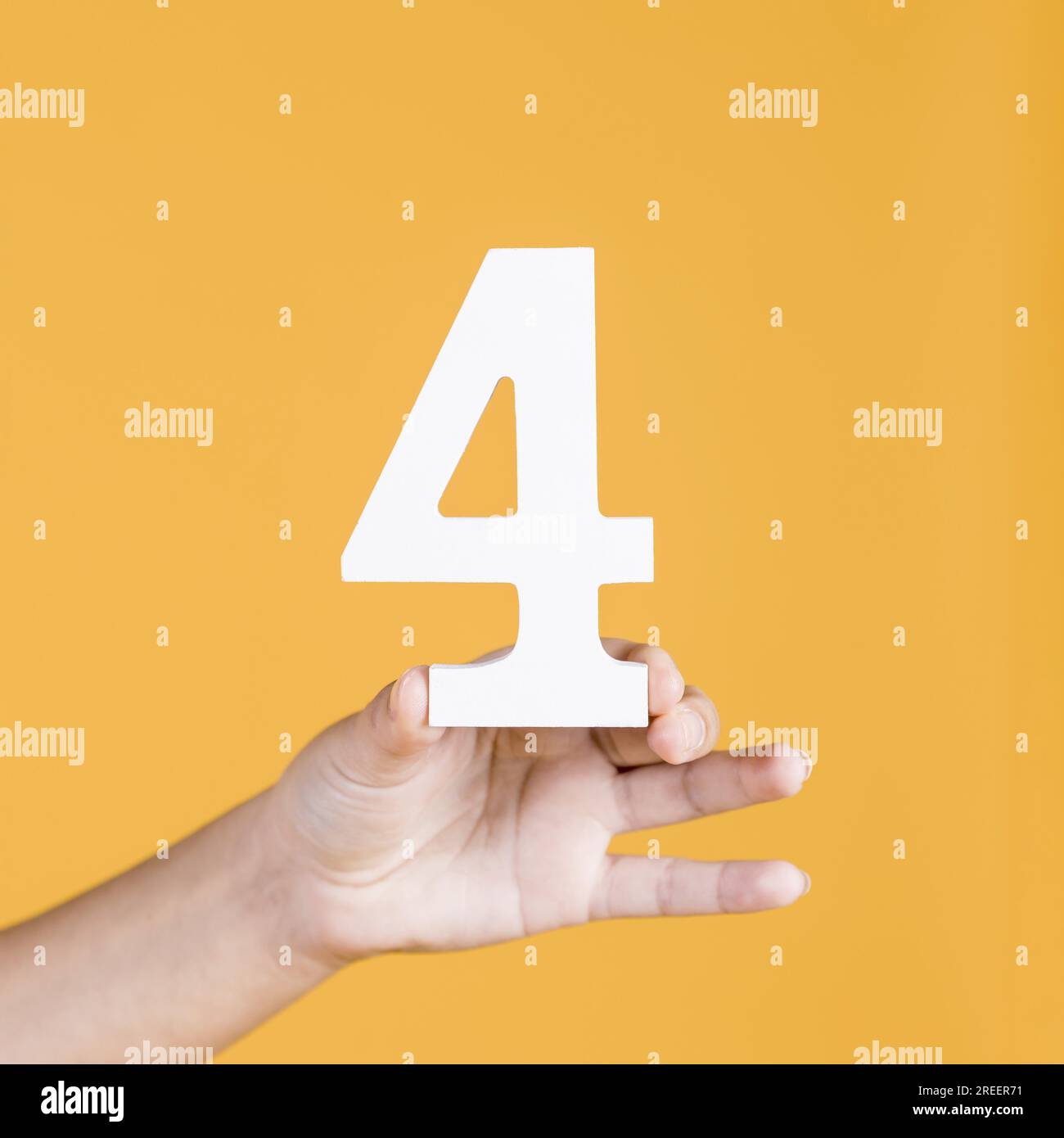 Woman s hand holding up number 4 against yellow background. Resolution ...