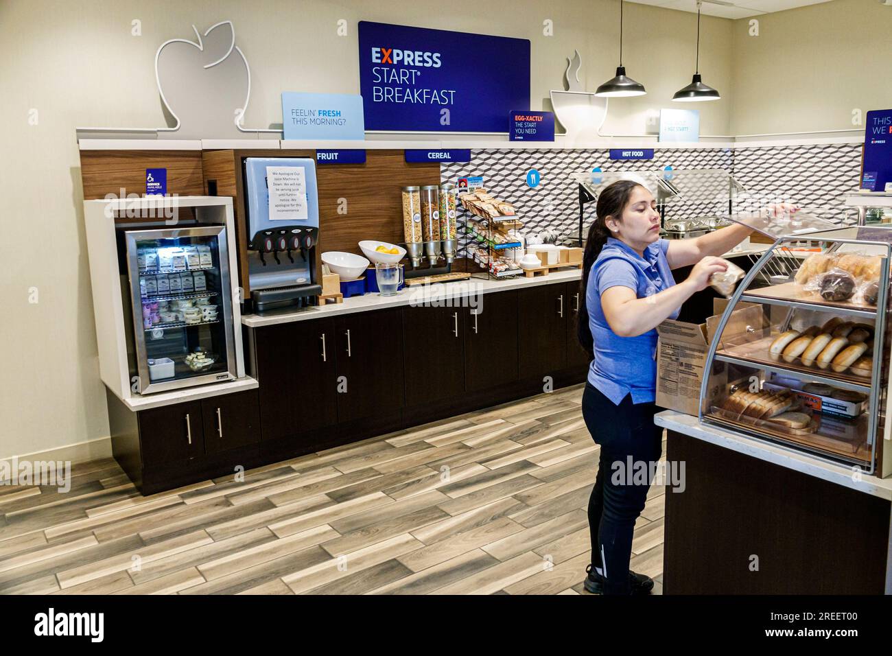 Hispanic woman employee worker replenishing hi-res stock photography ...