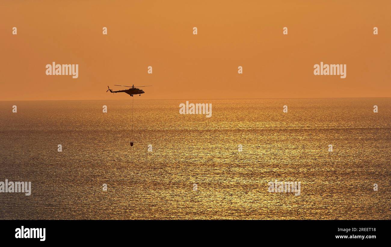 Helicopter, helicopter, fire-fighting helicopter, close over the sea ...