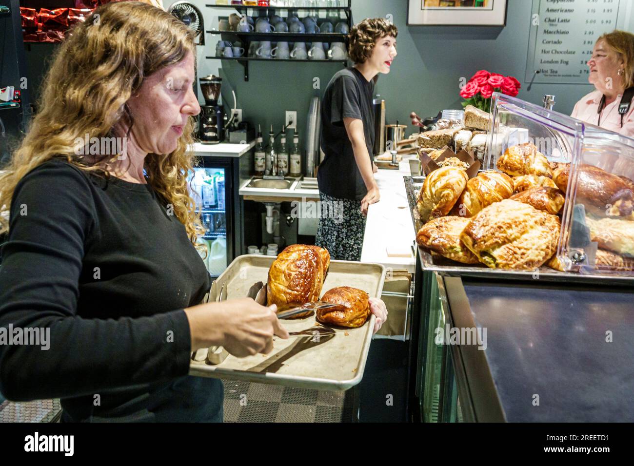 Employee worker baker adding buns pastries hi-res stock photography and ...