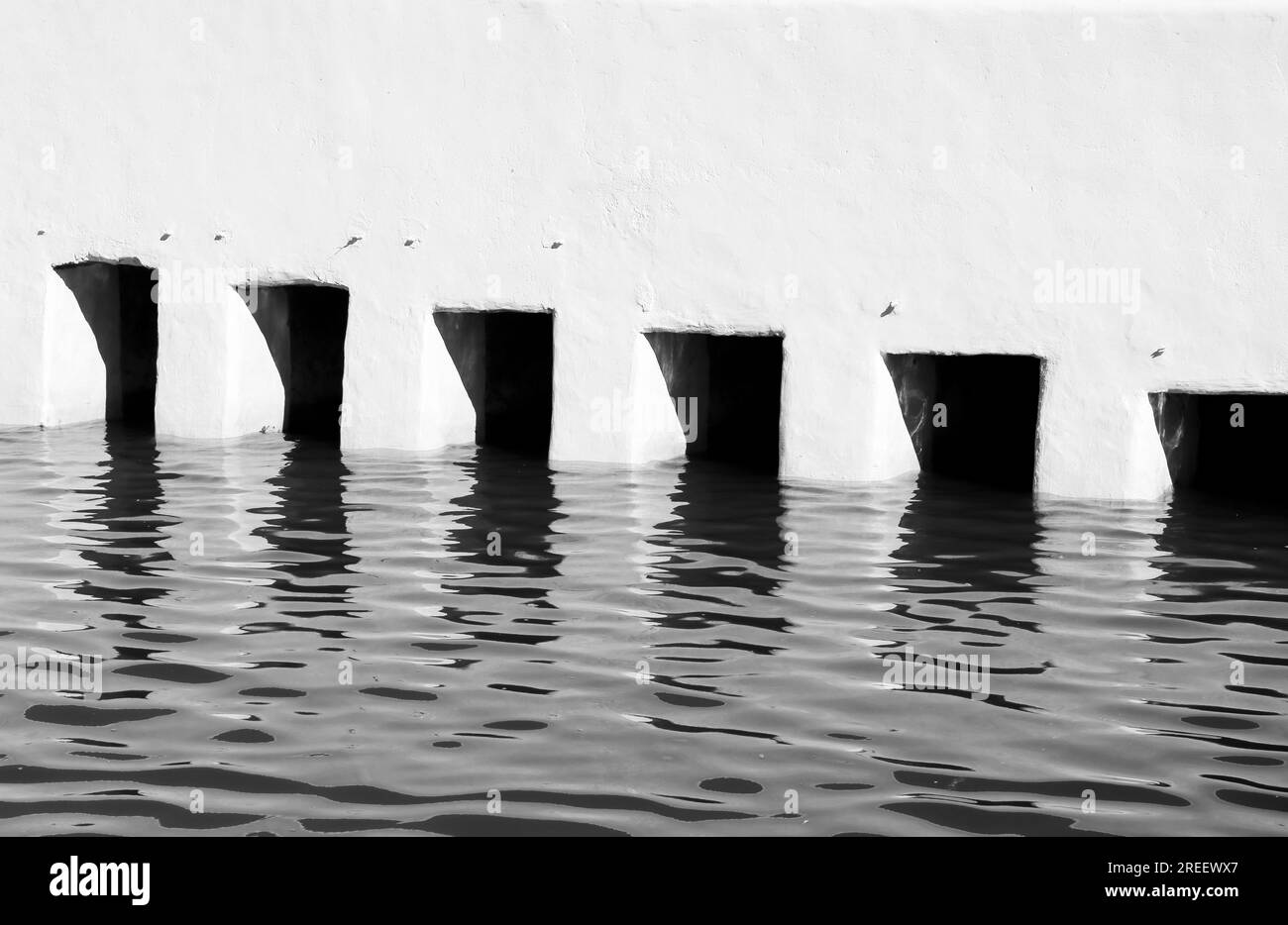 Square openings for the passage of water in a channel . Monochrome ...